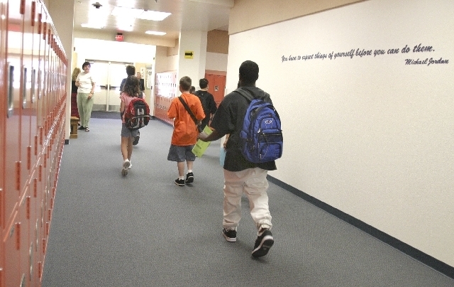 Students at Jerome Mack Middle School hike to class loaded with books ...