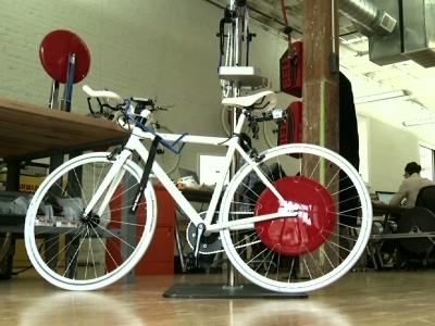 Red wheel captures energy, turning bicycles into hybrids | Business