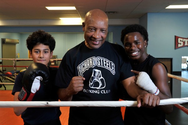 Retired professional boxing referee Richard Steele, center, poses in ...