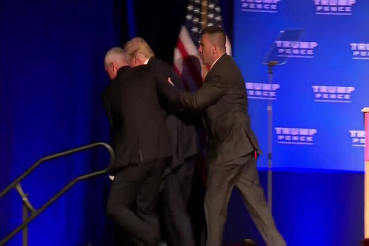 Donald Trump returns to finish speech after being rushed off stage amid ...